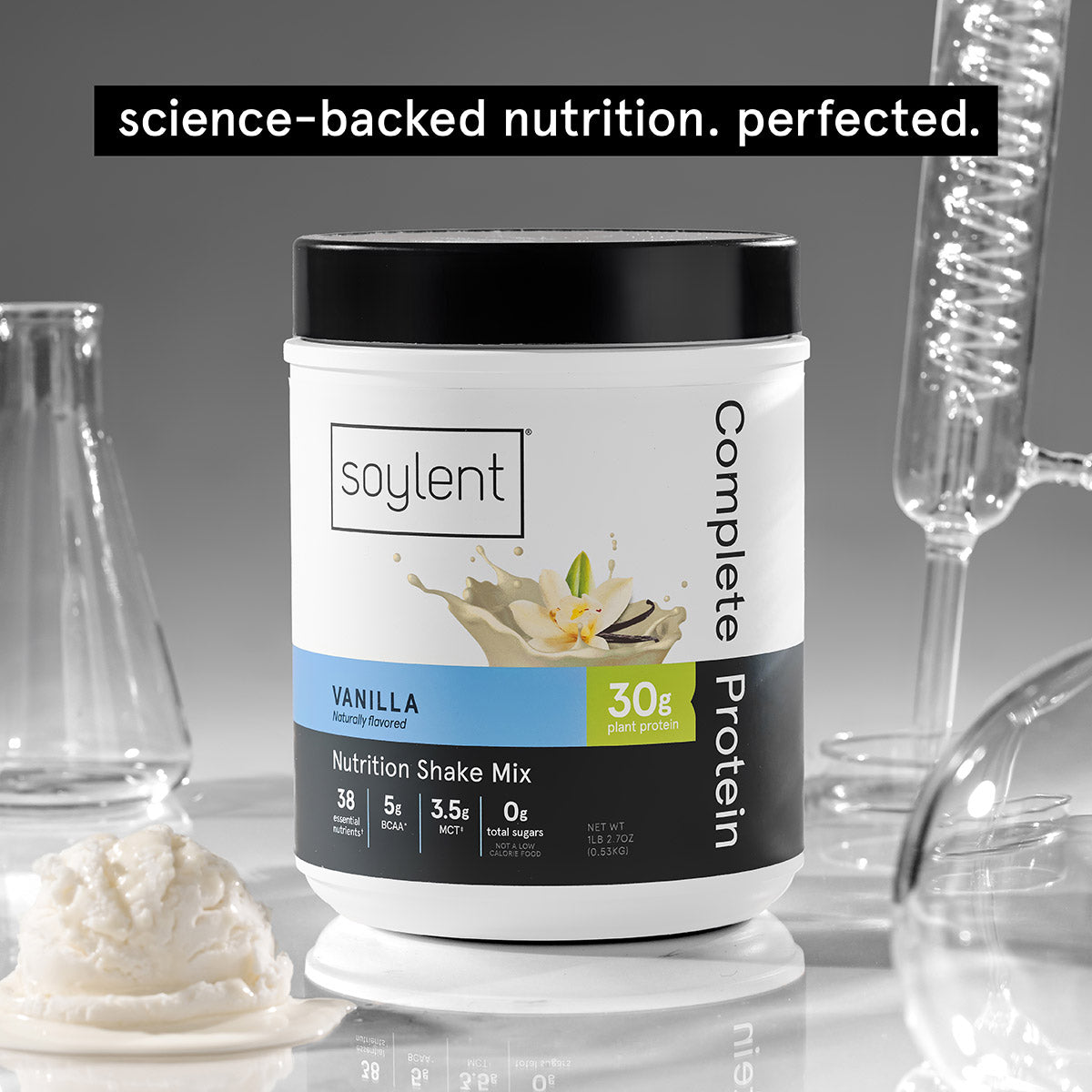 Soylent Complete protein powder tub in vanilla displayed in a lab next ...